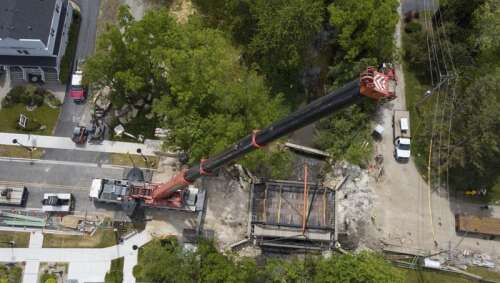 Watch: Crane puts historic Long Grove bridge back in place on way to ...