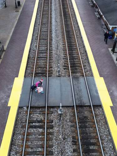 Suburban Skyview: Metra rider catches a train in downtown Itasca