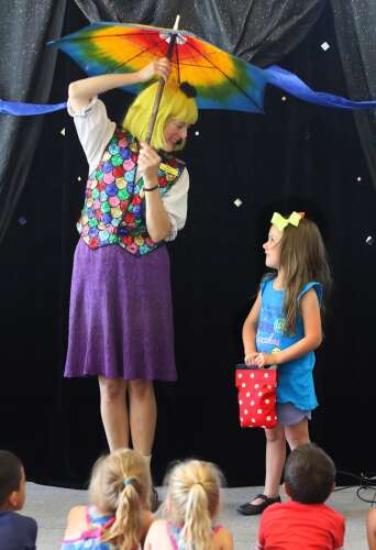 Mary Macaroni laughs with children at Vernon Hills library